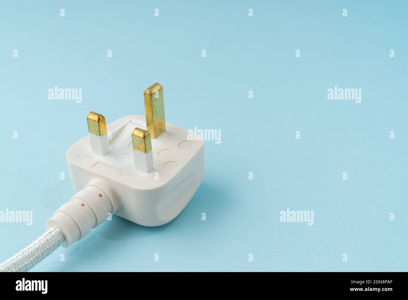 Three pin plug on light blue background with a copy space Stock Photo ...