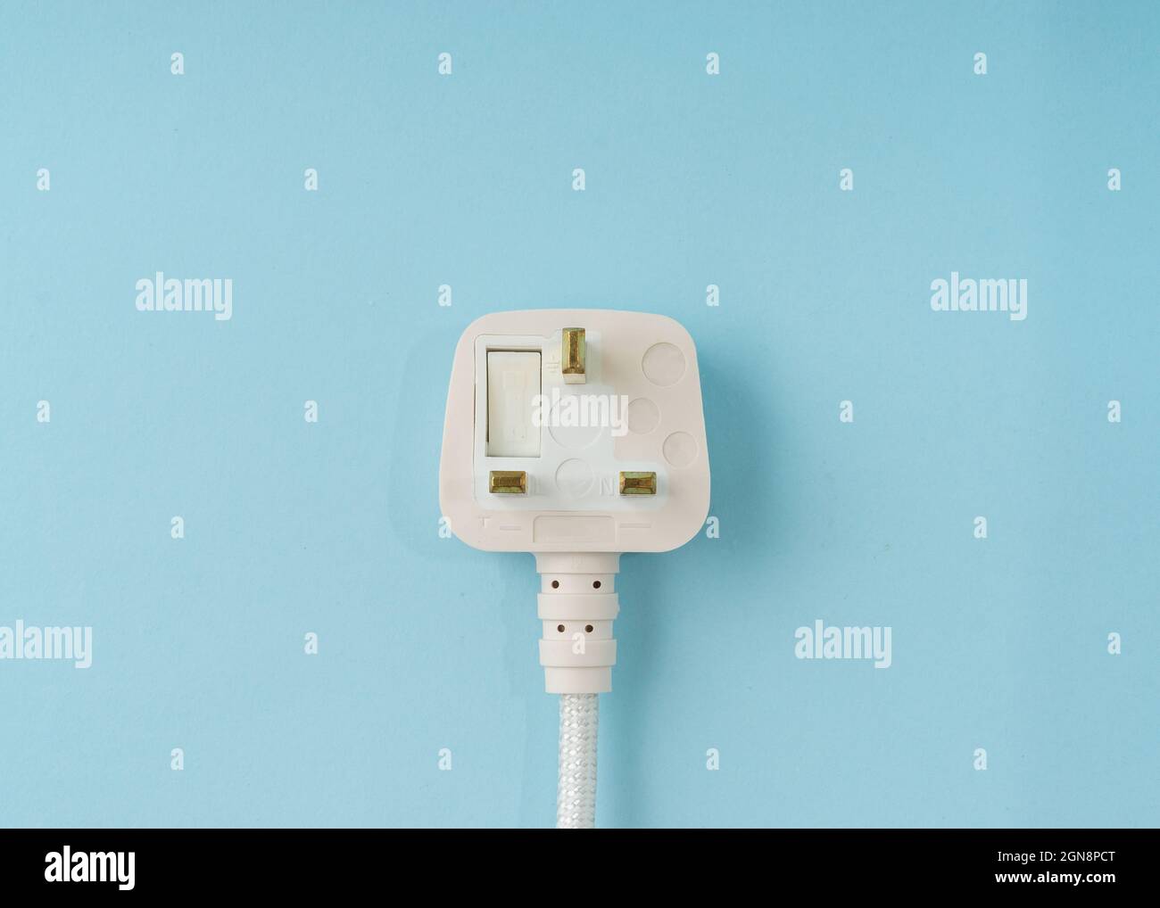 Three pin plug on light blue background with a copy space Stock Photo ...