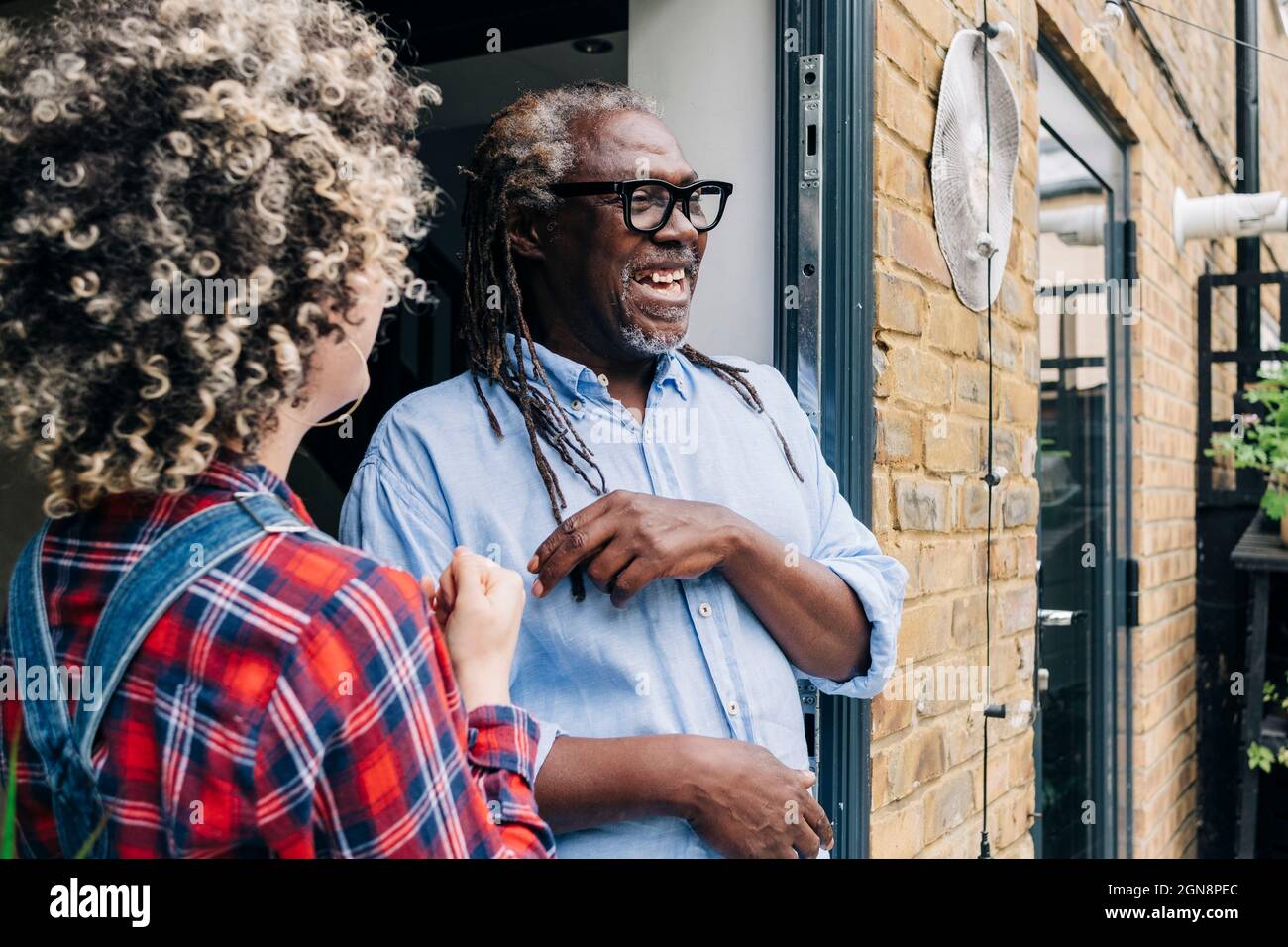 Cheerful father standing with daughter at balcony Stock Photo - Alamy