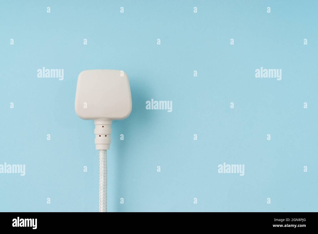 Three pin plug on light blue background with a copy space Stock Photo ...
