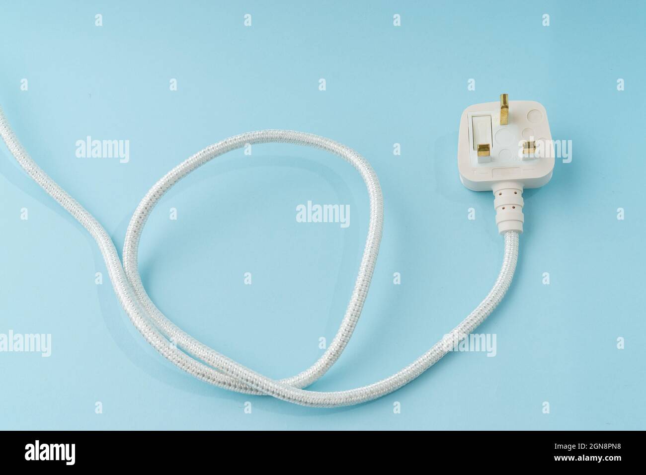 Three pin plug on light blue background with a copy space Stock Photo ...