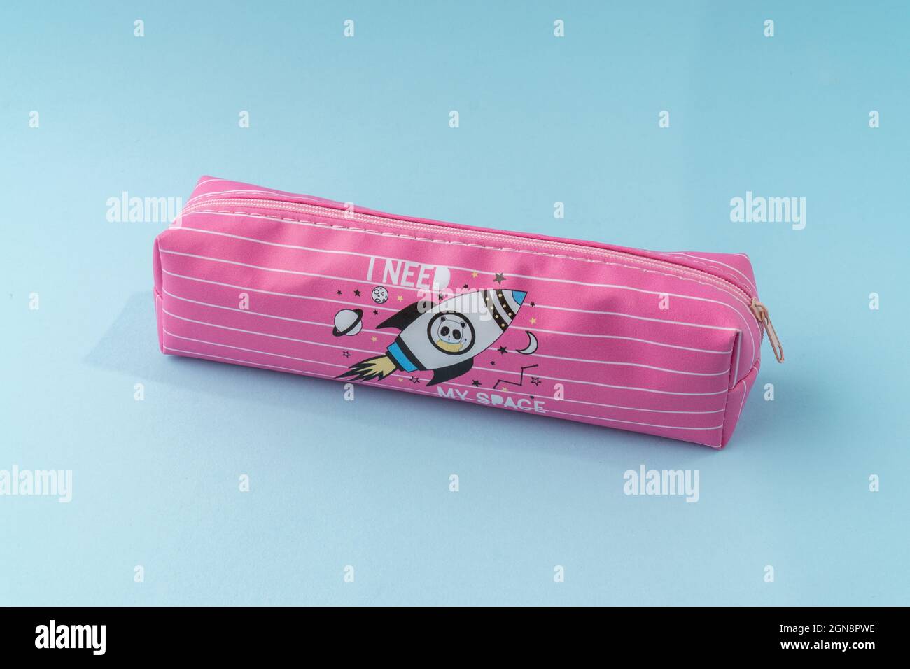 Pink color pencil box on light blue background Stock Photo - Alamy