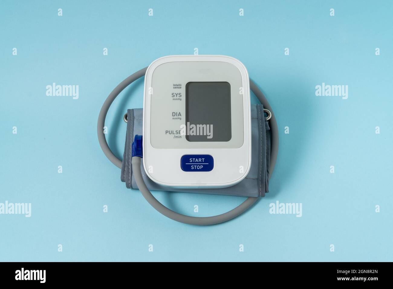 Blood pressure monitor on light blue background Stock Photo - Alamy