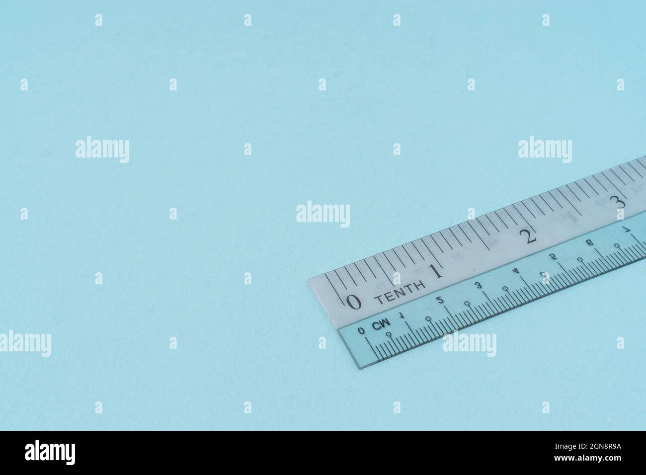 Plastic ruler on light blue background Stock Photo - Alamy