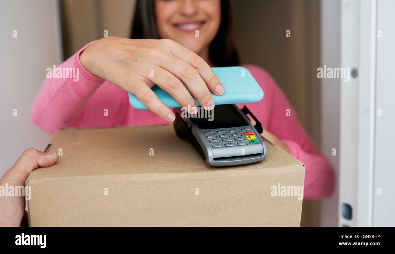 Woman paying through mobile phone Stock Photo - Alamy
