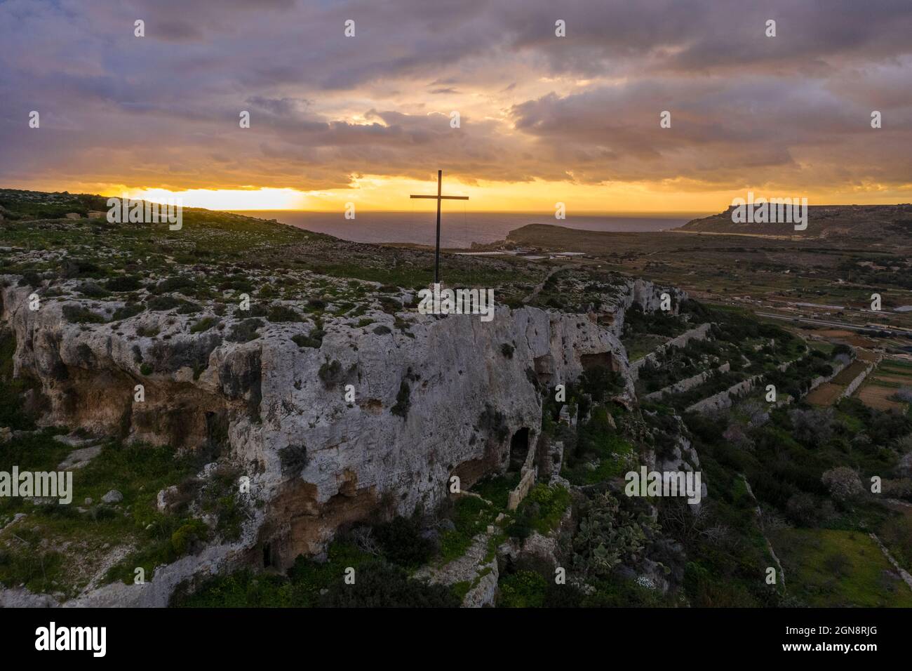 Hilltop cross at dramatic sunset Stock Photo - Alamy