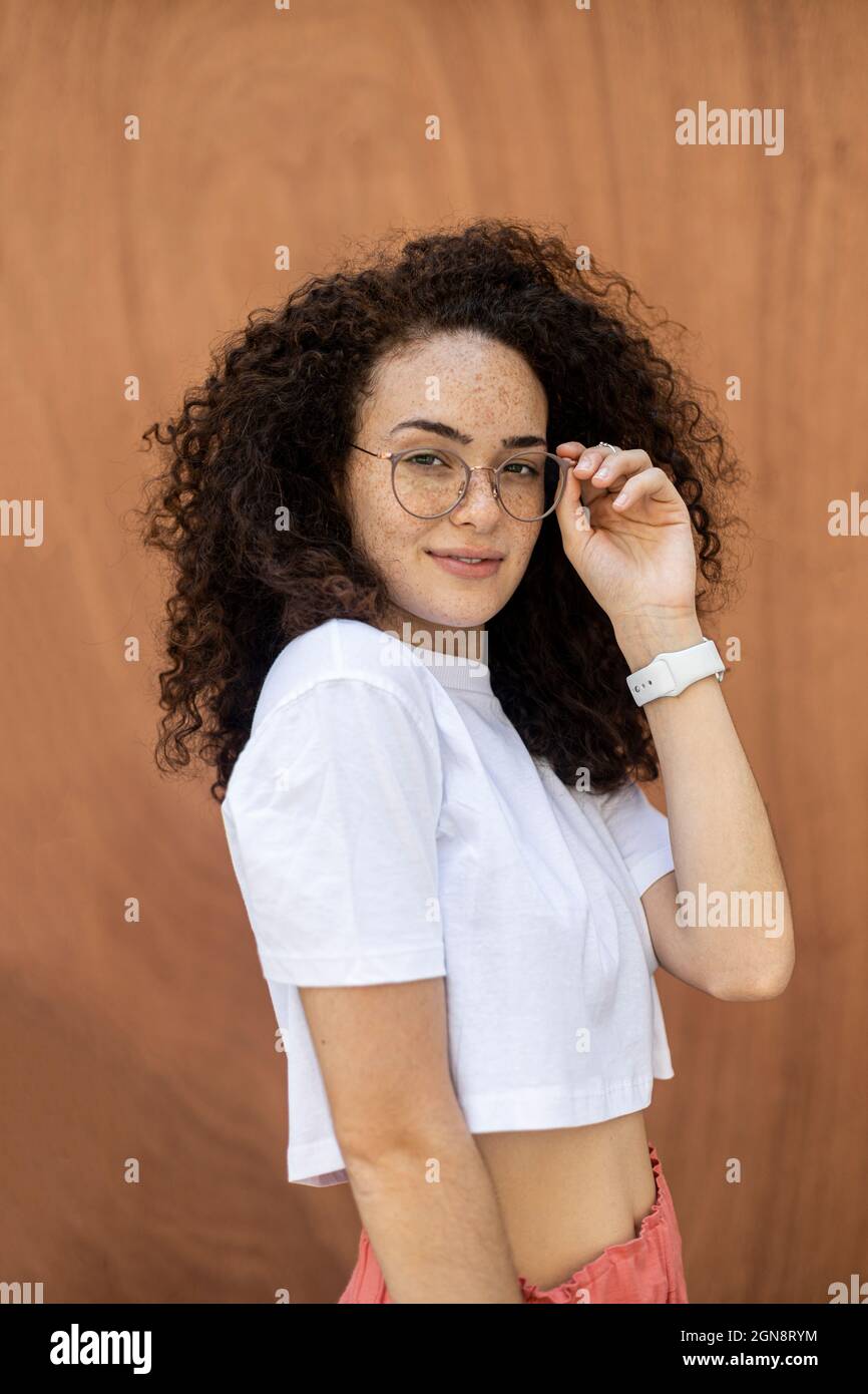 Eyeglasses holding woman hi-res stock photography and images - Alamy