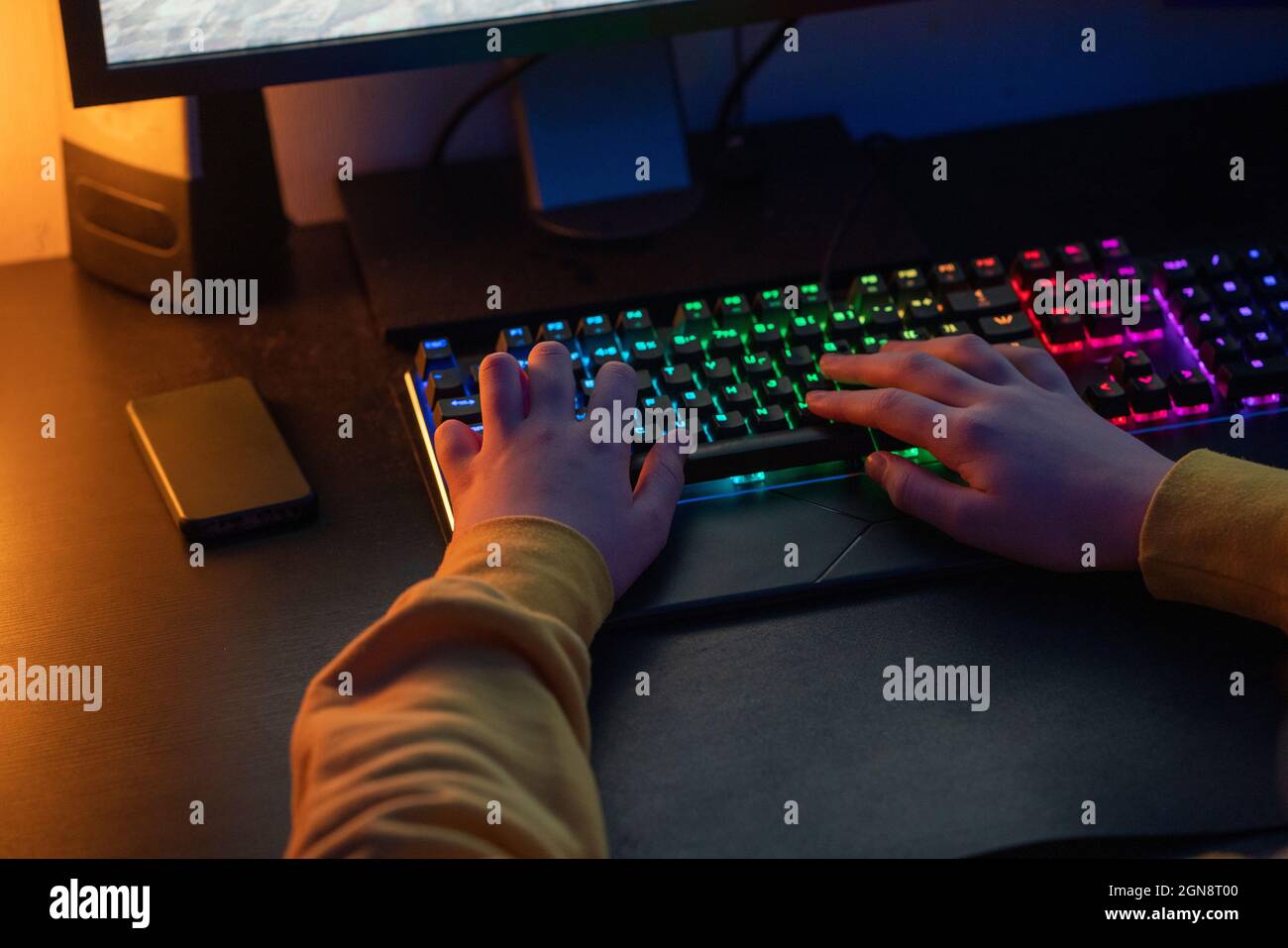 Boy typing on keyboard at home Stock Photo - Alamy