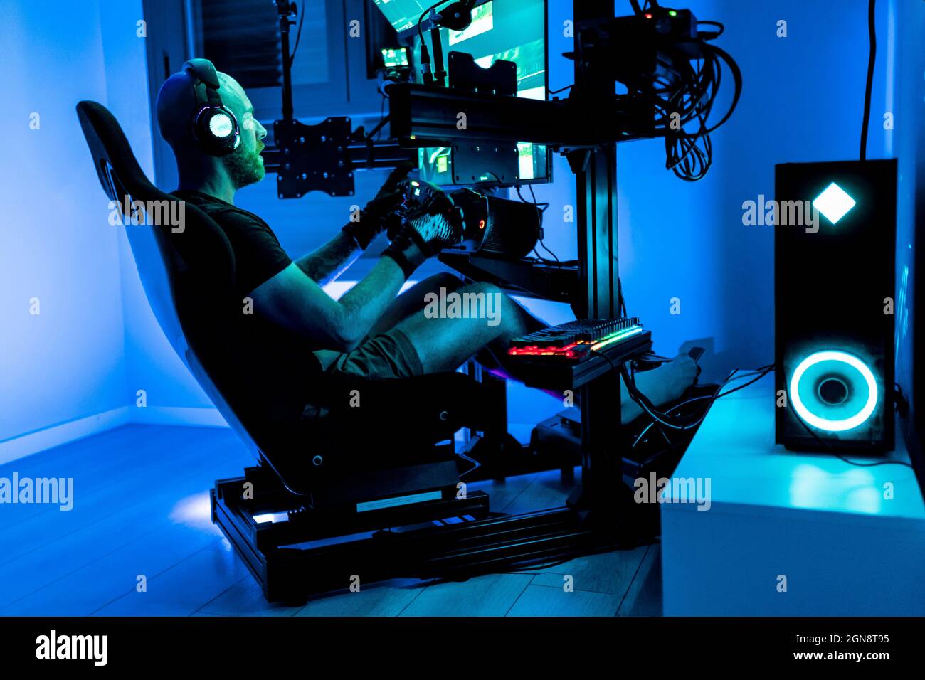 Mid adult man playing video game at studio Stock Photo - Alamy