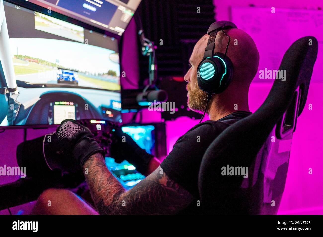 Mid adult male gamer playing video game at studio Stock Photo - Alamy
