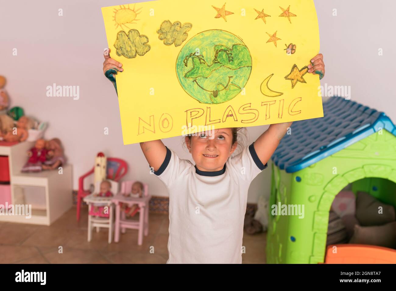 Girl looking at poster while standing at home Stock Photo - Alamy
