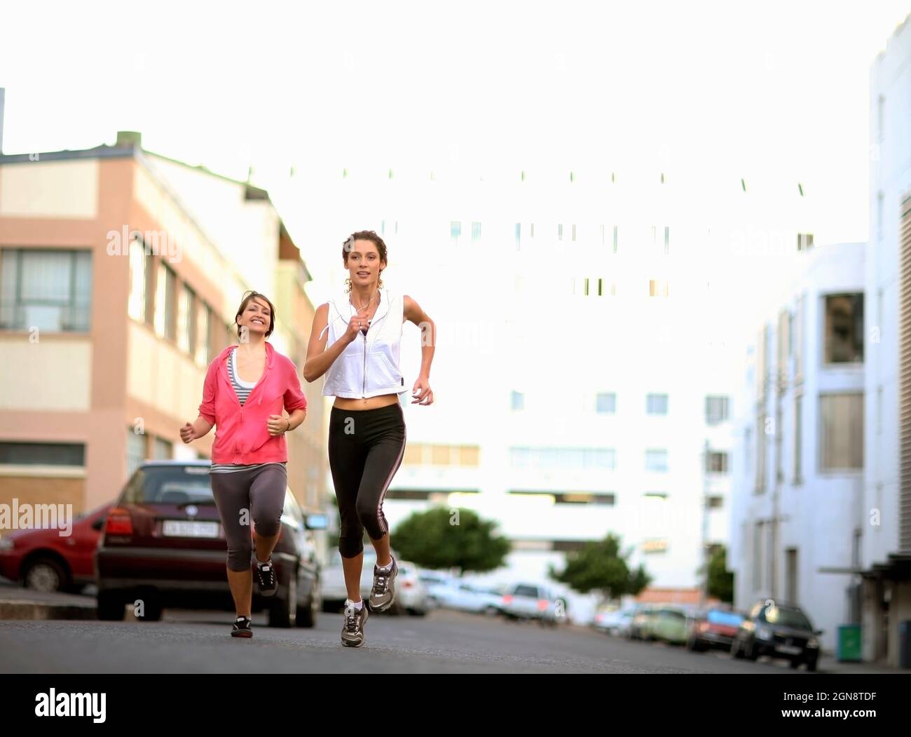 Female runner running on road hi-res stock photography and images - Alamy