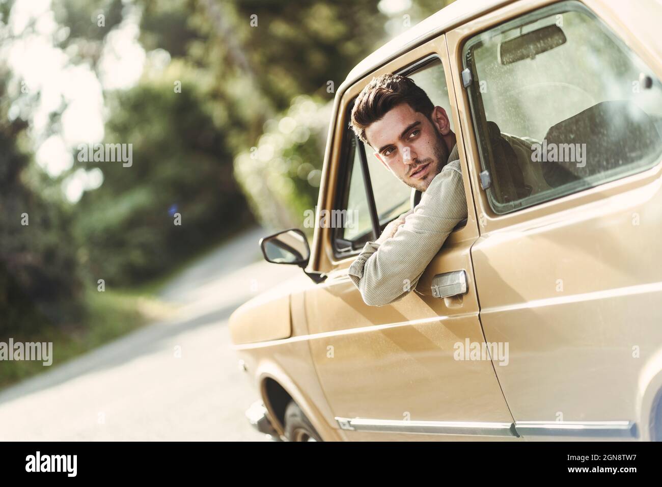 Man looking sitting in car, looking out of window Stock Photo - Alamy