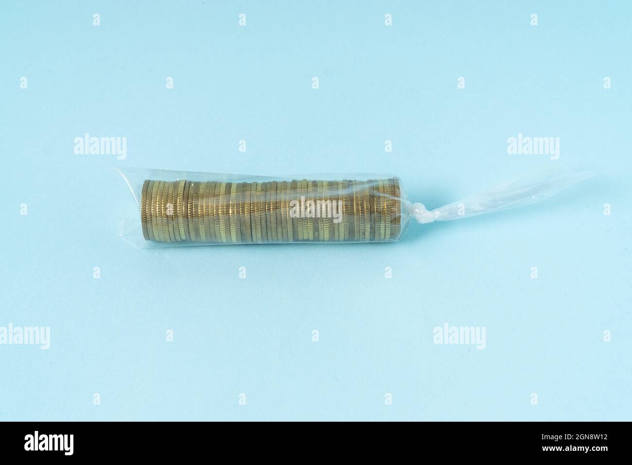 Stack of coins in a plastic bag Stock Photo - Alamy