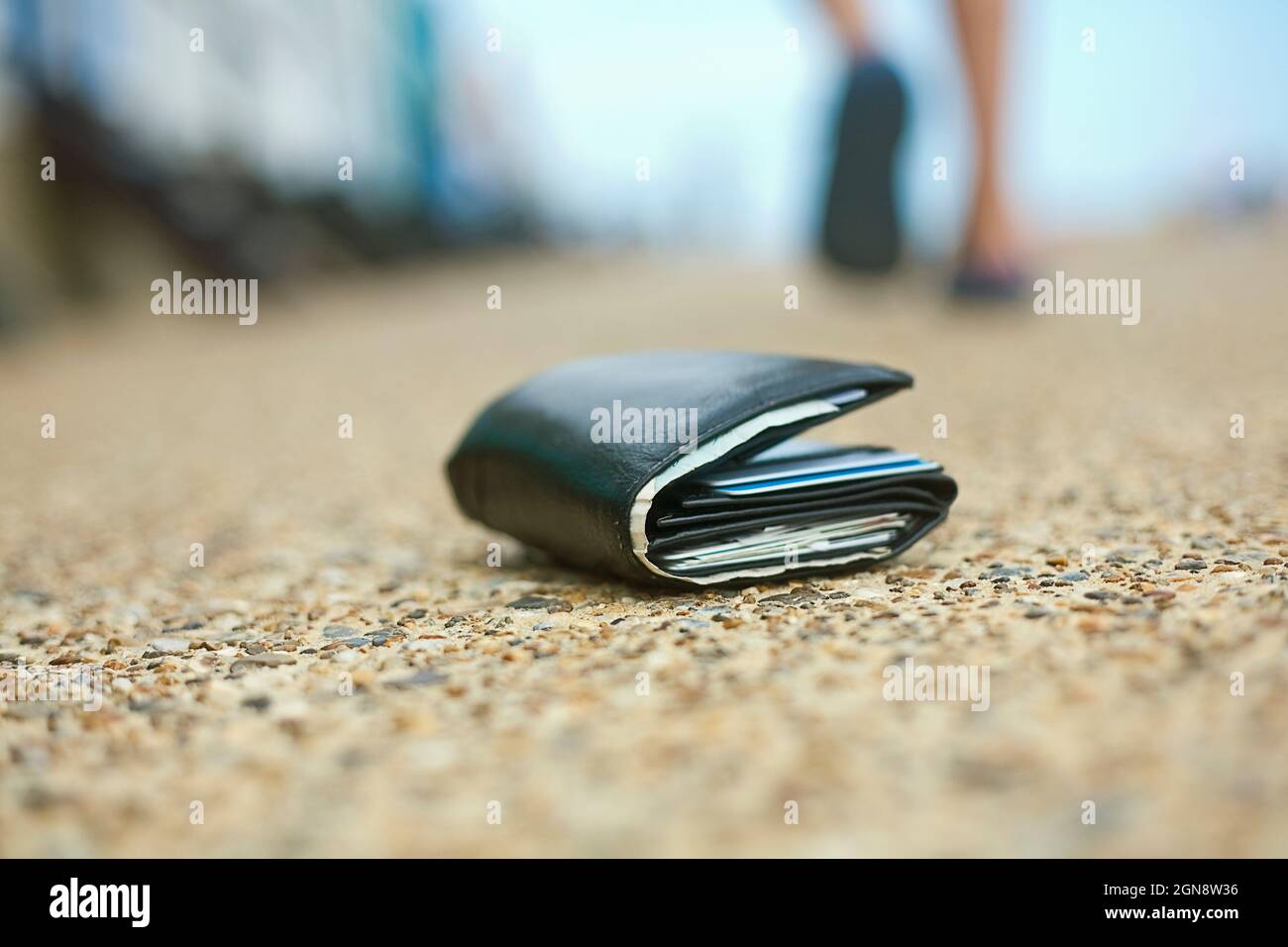 Lost wallet lying on ground Stock Photo - Alamy
