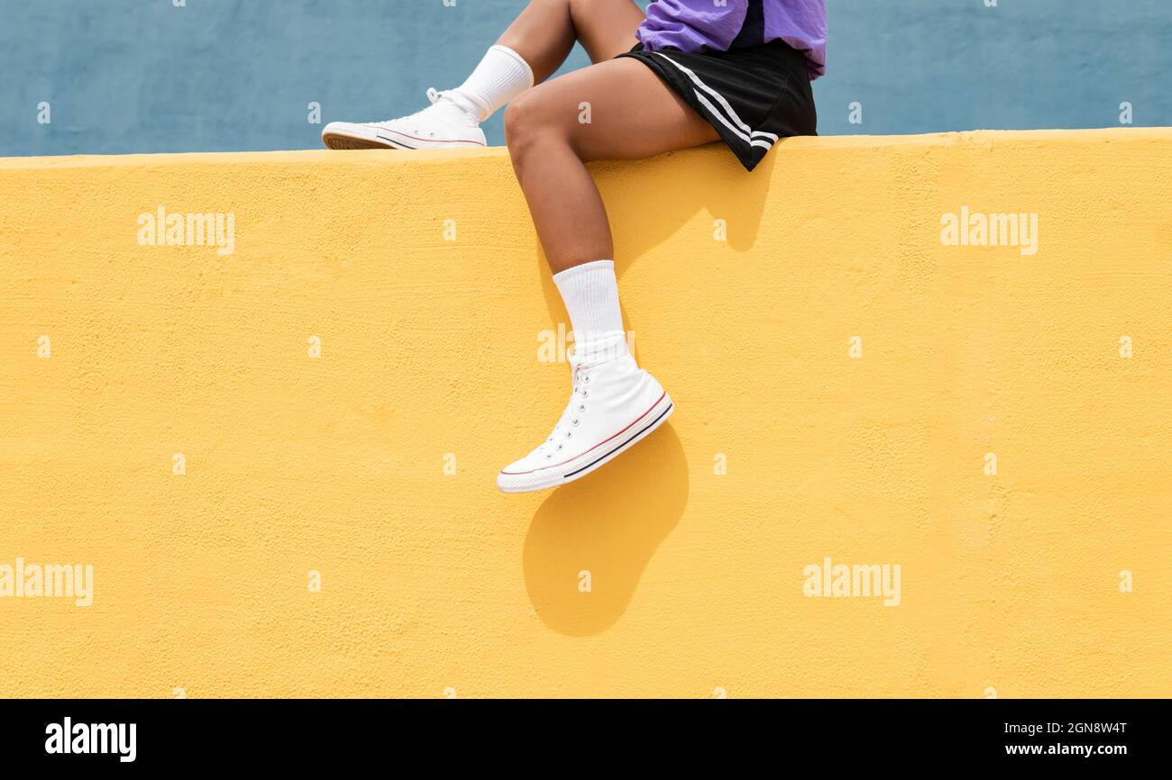 Adult woman sitting yellow hi-res stock photography and images - Alamy