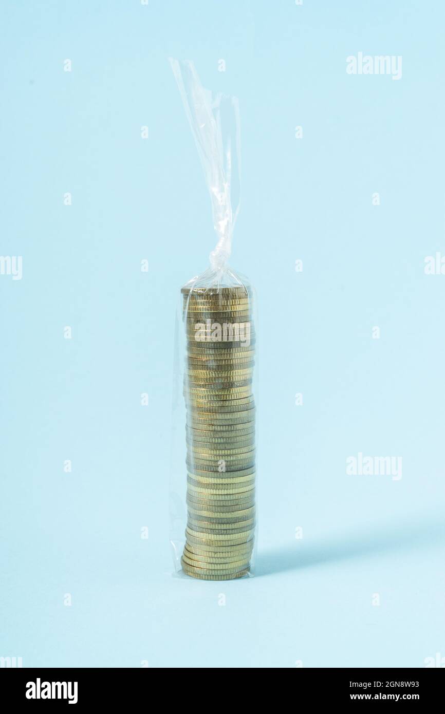 Stack of coins in a plastic bag Stock Photo - Alamy