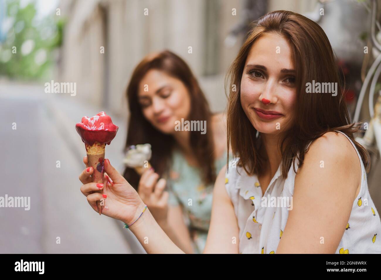Female friends having ice cream together Stock Photo - Alamy