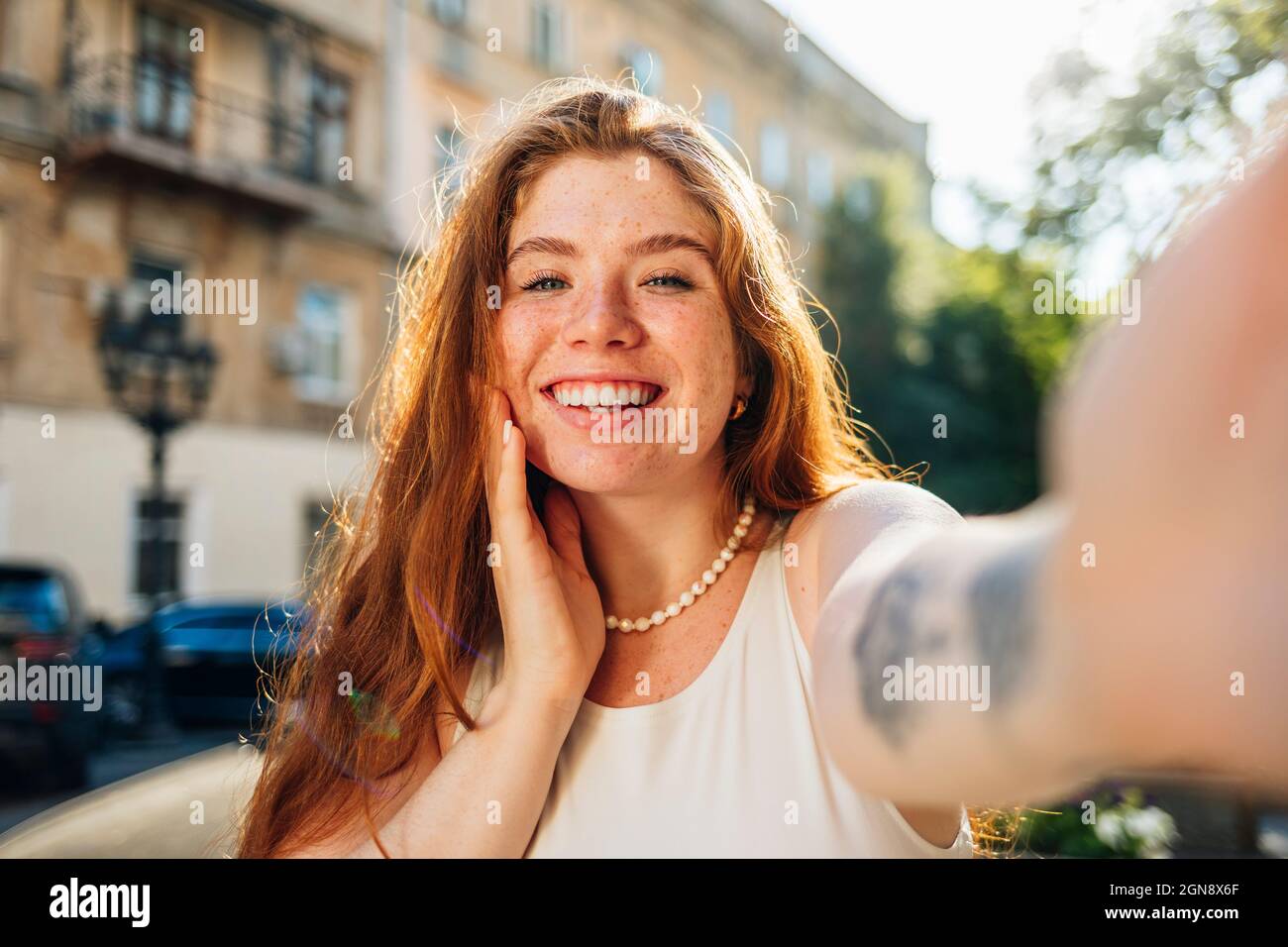 Smiling young woman talking selfie Stock Photo - Alamy