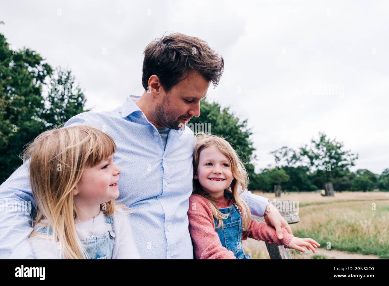 Arms around smiling hi-res stock photography and images - Alamy