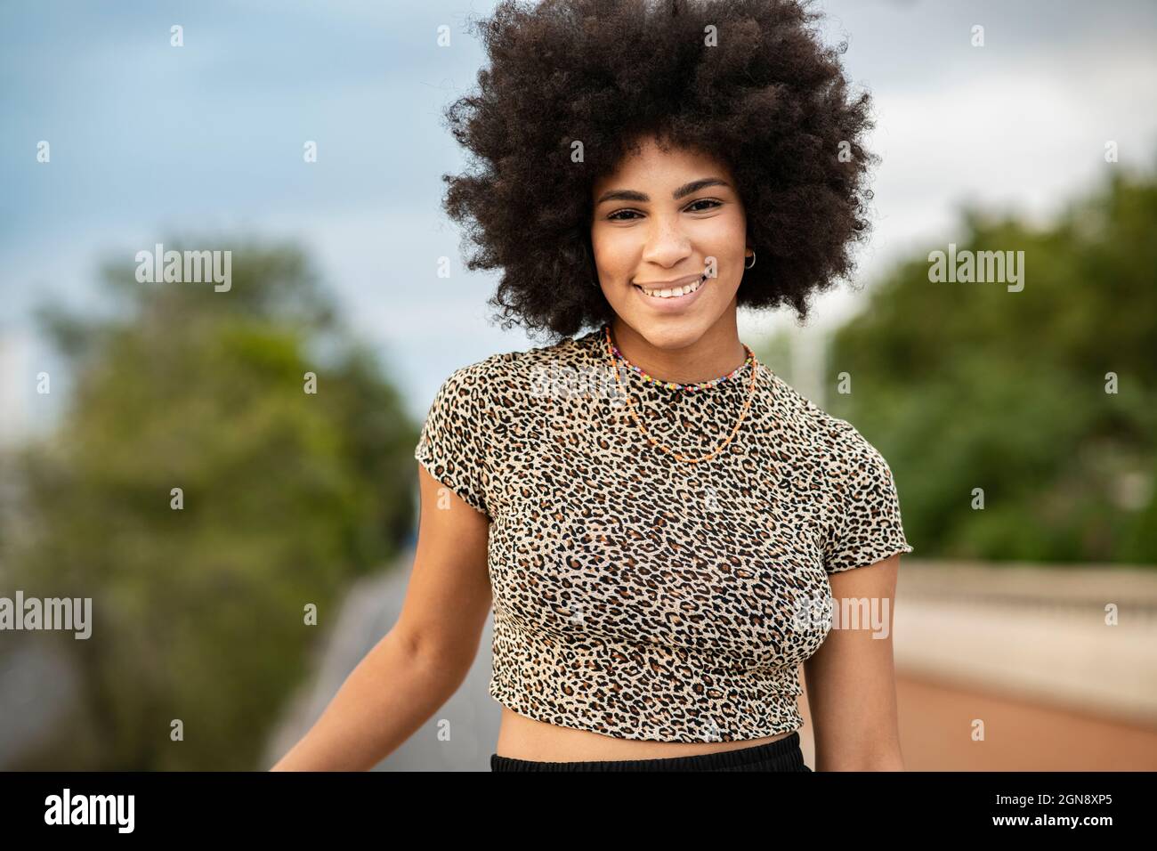 Young woman wearing leopard print top hi-res stock photography and ...