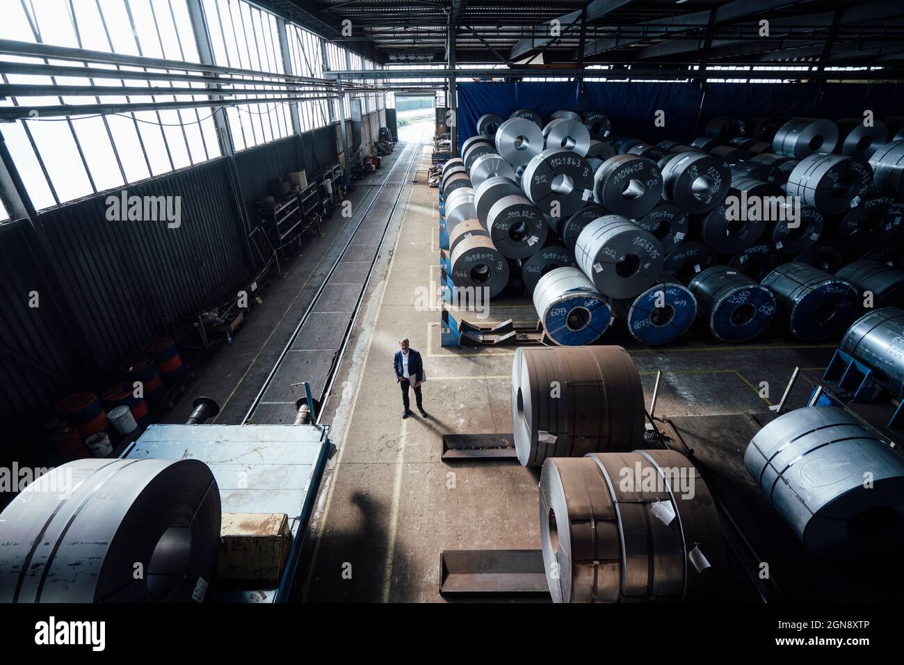 Male professional standing in steel mill Stock Photo - Alamy
