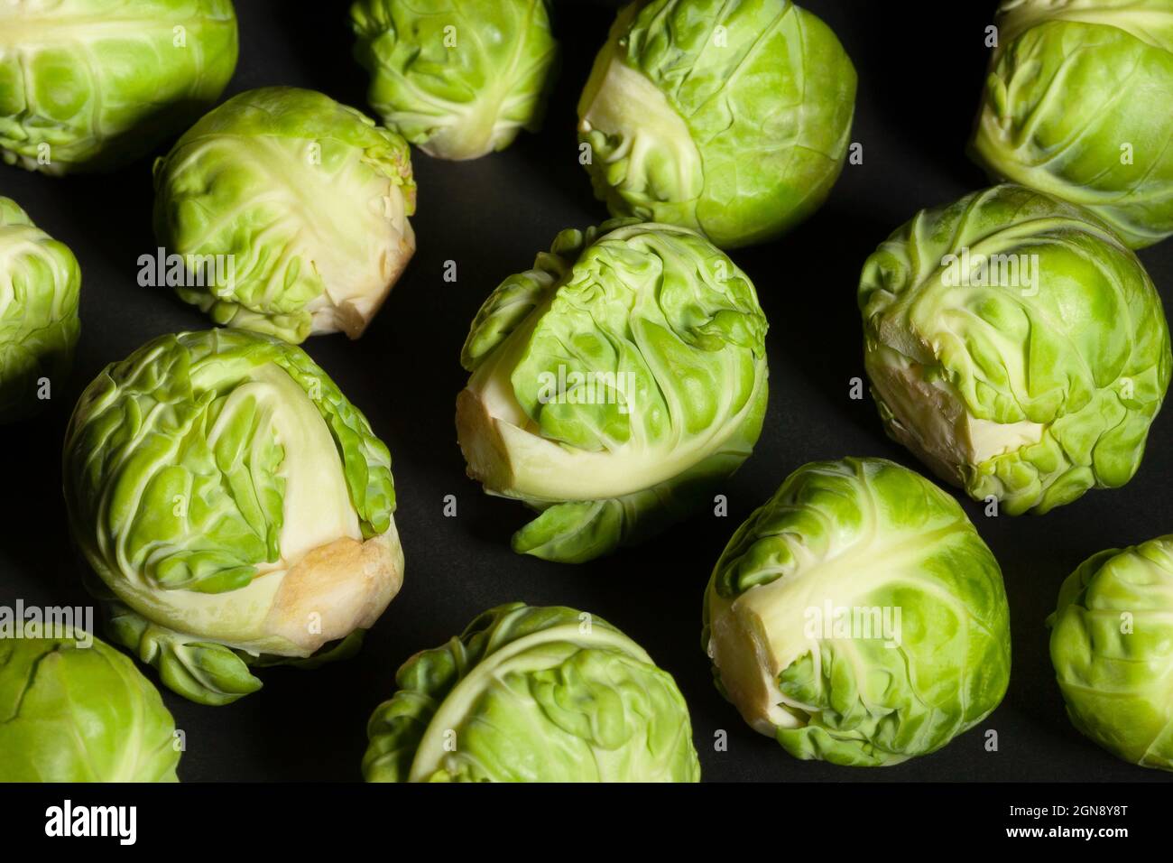 brussels sprouts on black background Stock Photo - Alamy