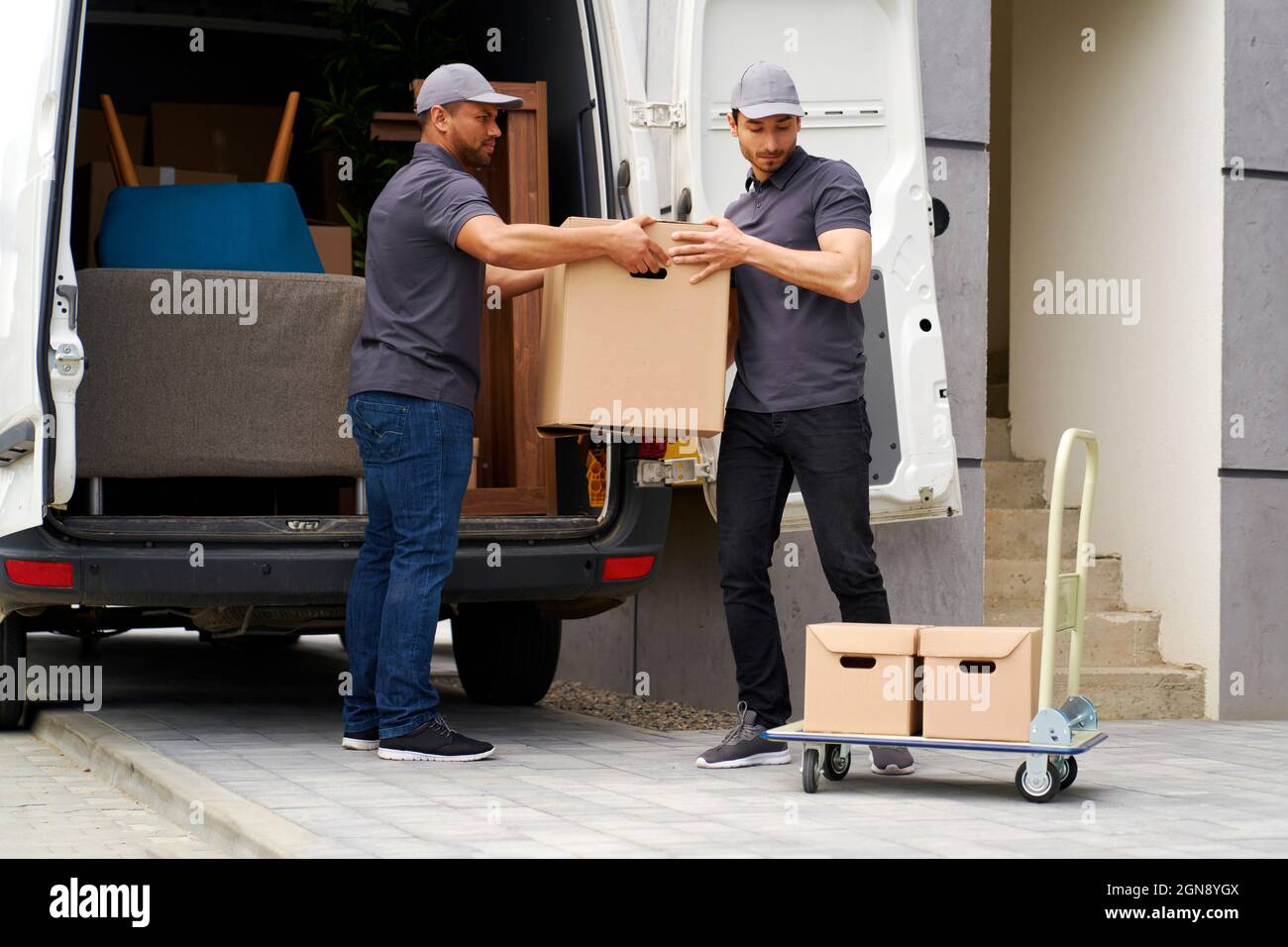 Delivery men unloading cardboard boxes hi-res stock photography and ...