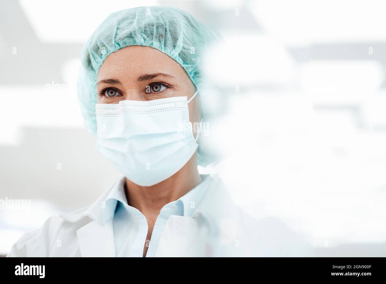 Female pharmacist wearing protective face mask at pharmacy during COVID ...
