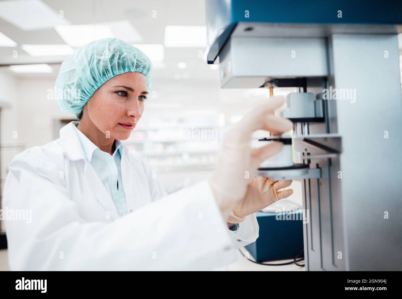 Female pharmacist working while using microscope in laboratory Stock ...