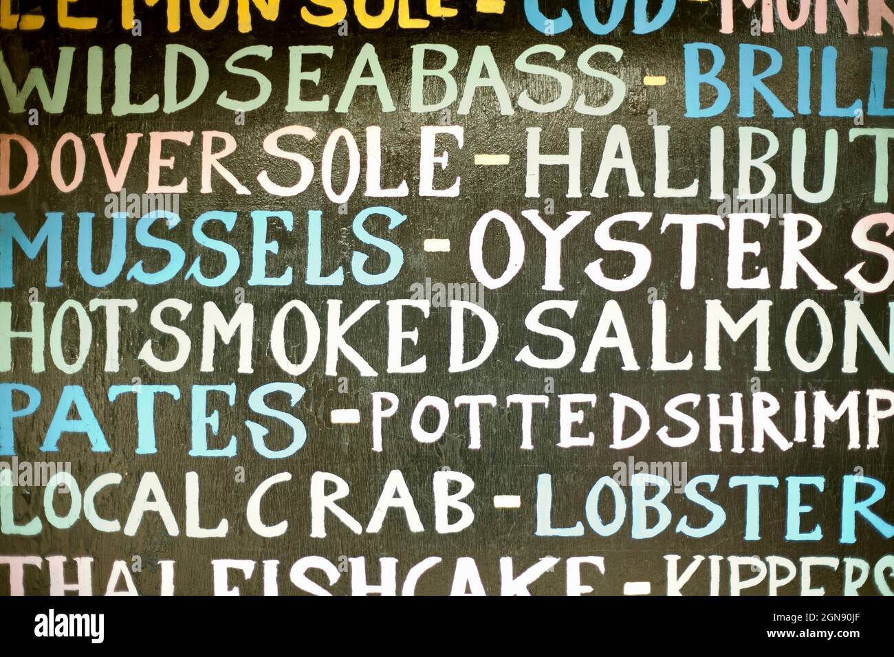 Hand painted sign listing seafood items Stock Photo - Alamy
