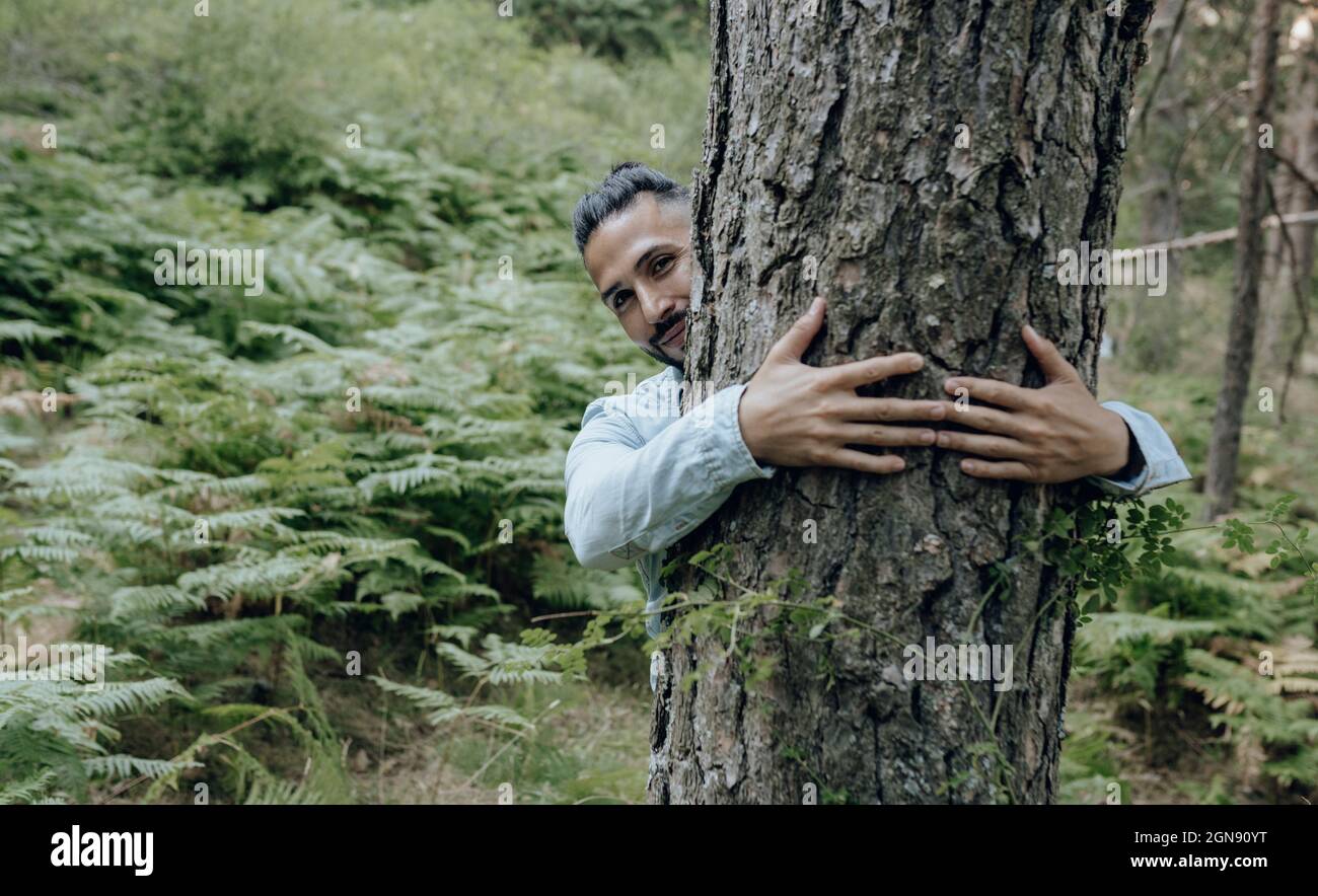 Man hugging tree hi-res stock photography and images - Alamy