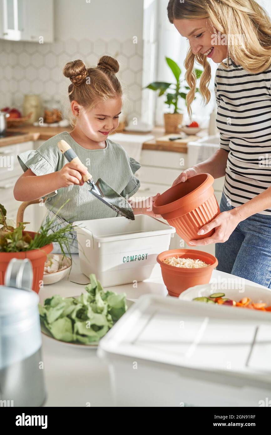 Mother and daughter preparing compost at home Stock Photo - Alamy