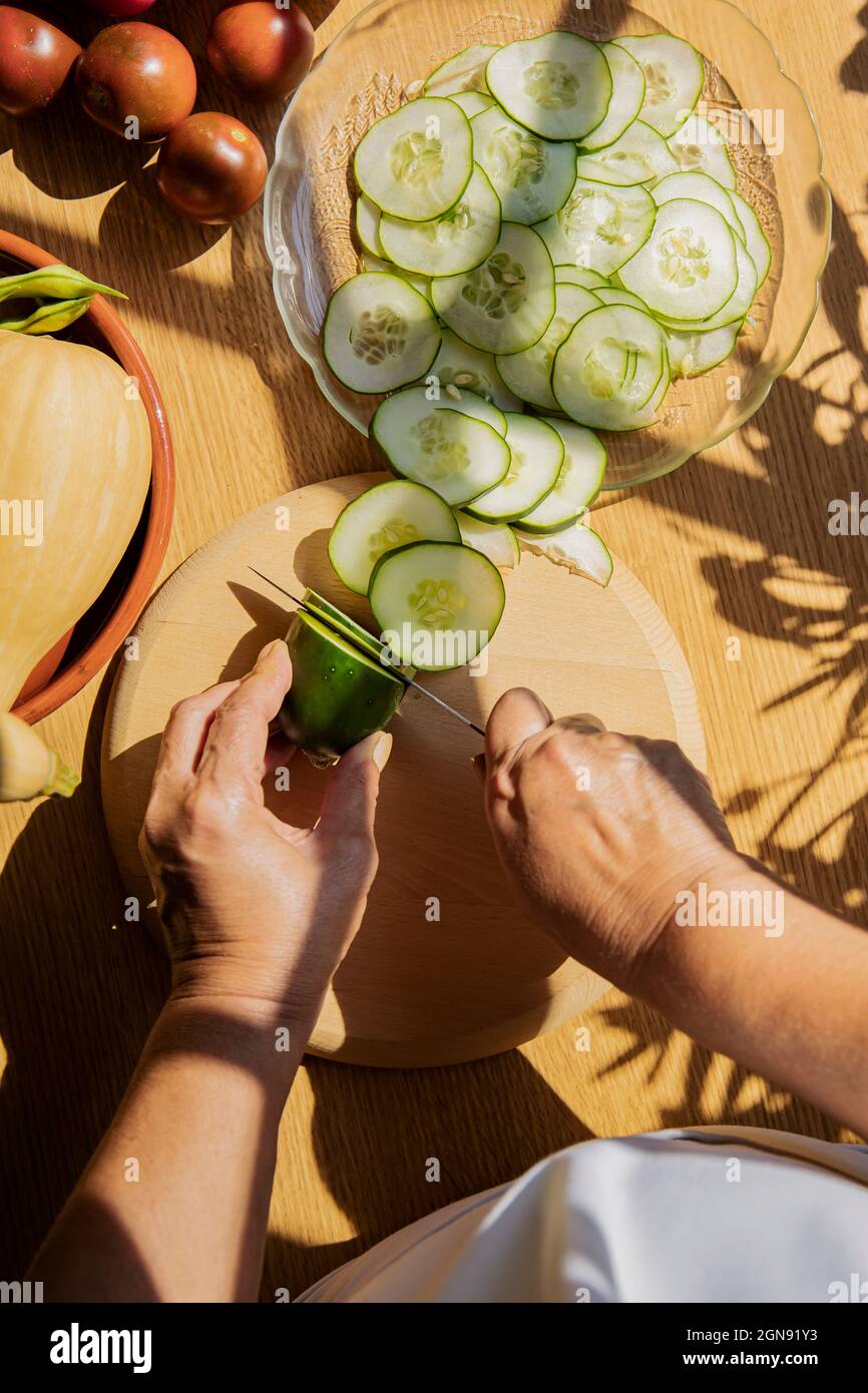 Person hand chopping cucumber hi-res stock photography and images - Alamy