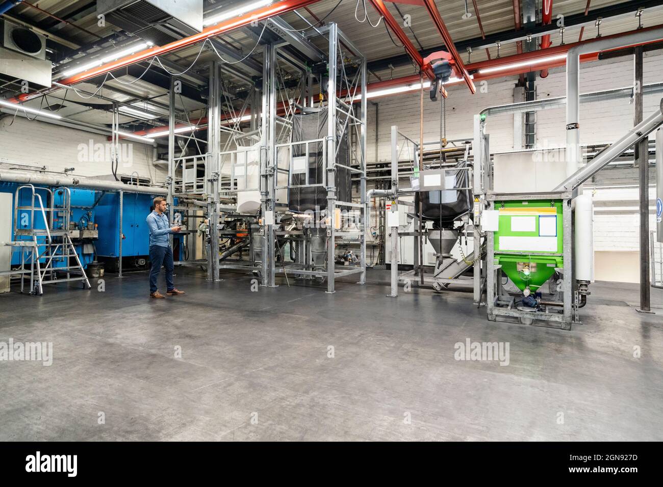 Male business professional standing at factory Stock Photo - Alamy