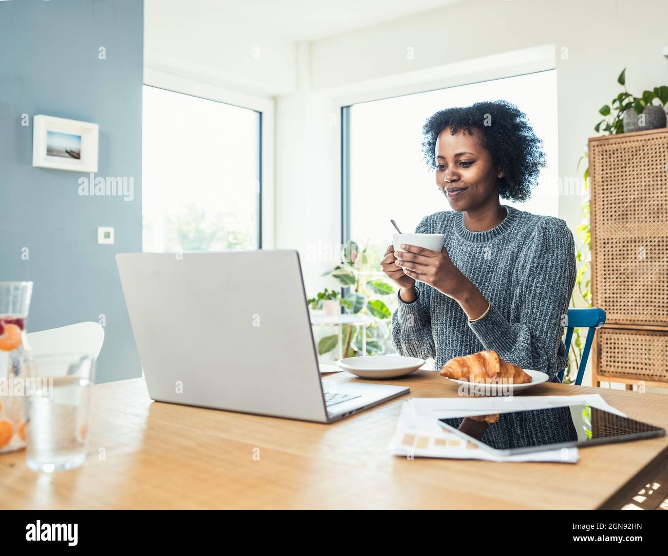 Female professional having coffee at home office Stock Photo - Alamy