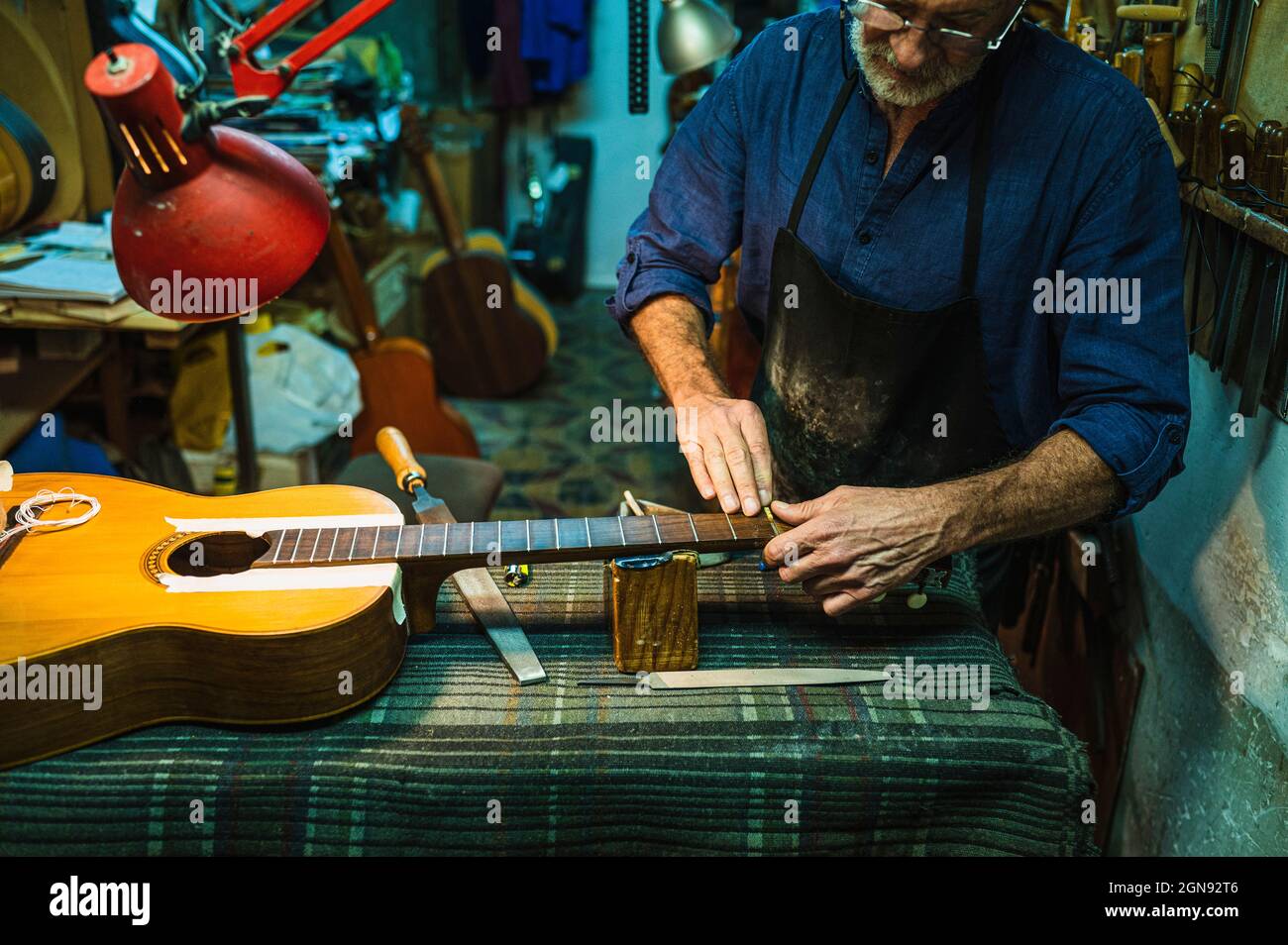 Male craftsperson shaping wood in workshop Stock Photo - Alamy