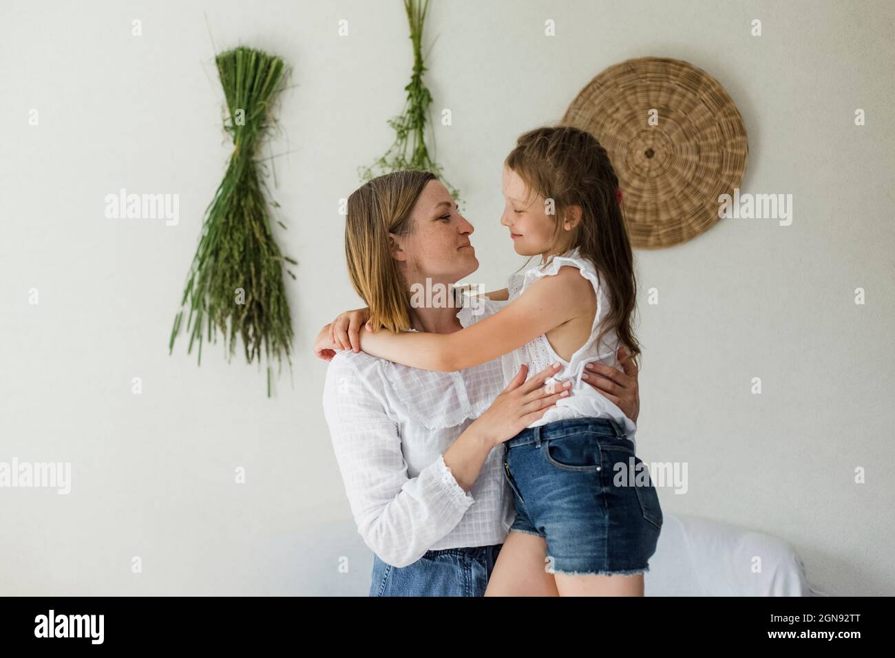 Woman embracing child hi-res stock photography and images - Alamy