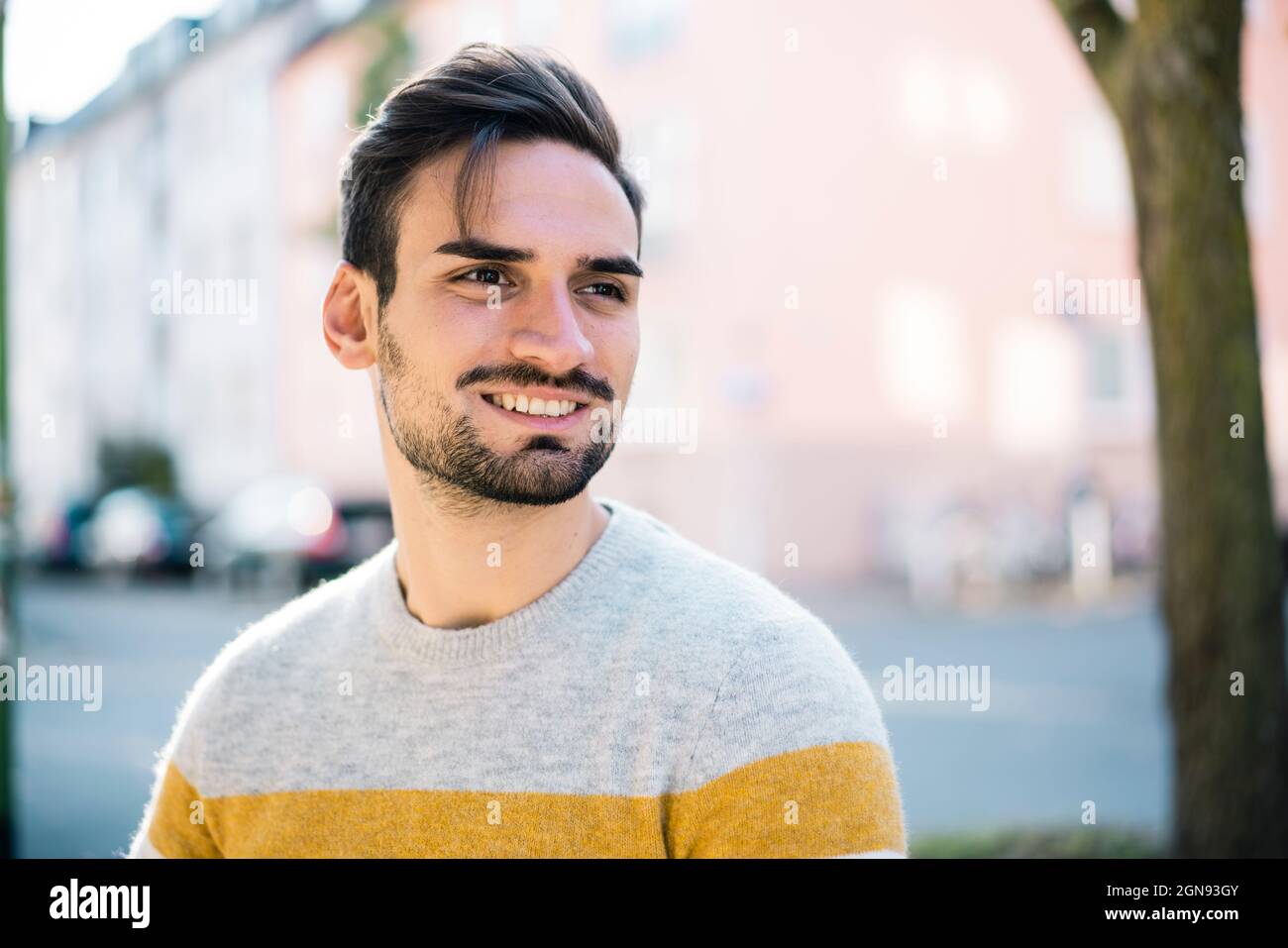Handsome young man with hair stubble at park Stock Photo - Alamy