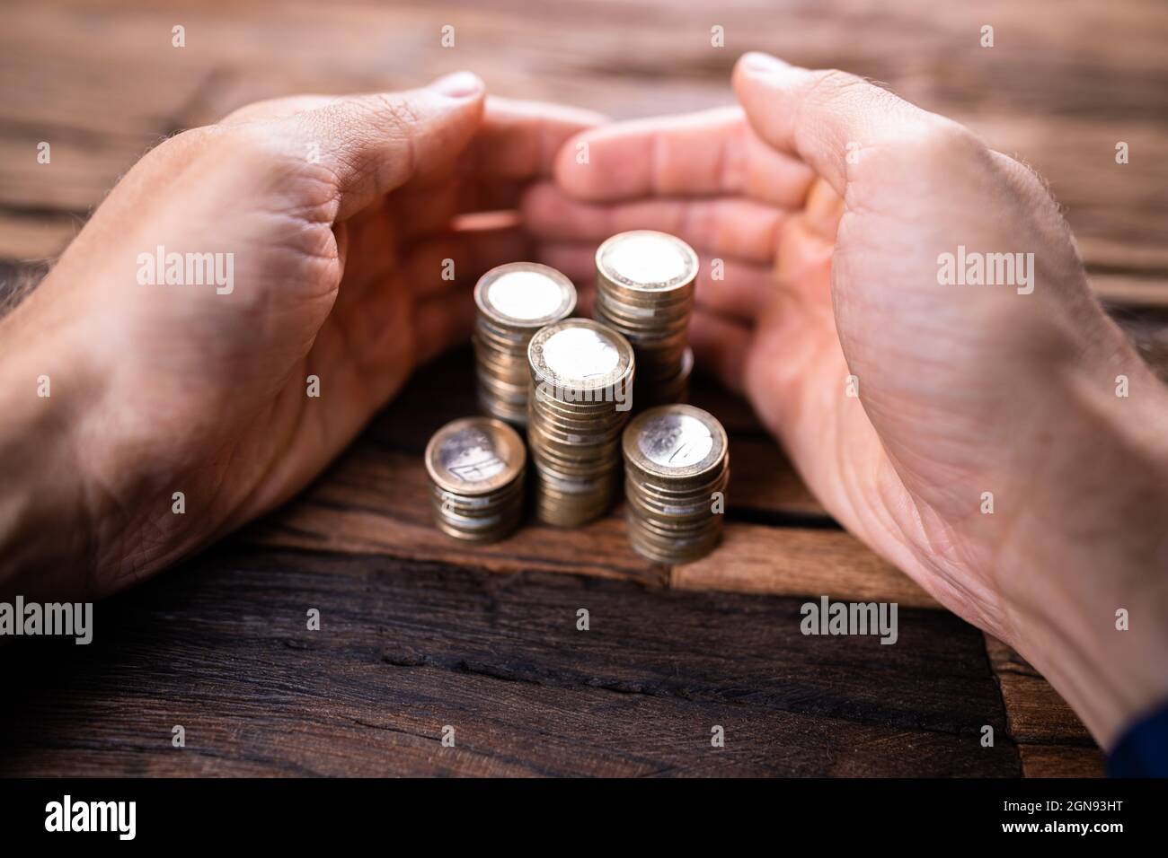 Save Business Money. Employee Protecting Budget Pile Stock Photo - Alamy