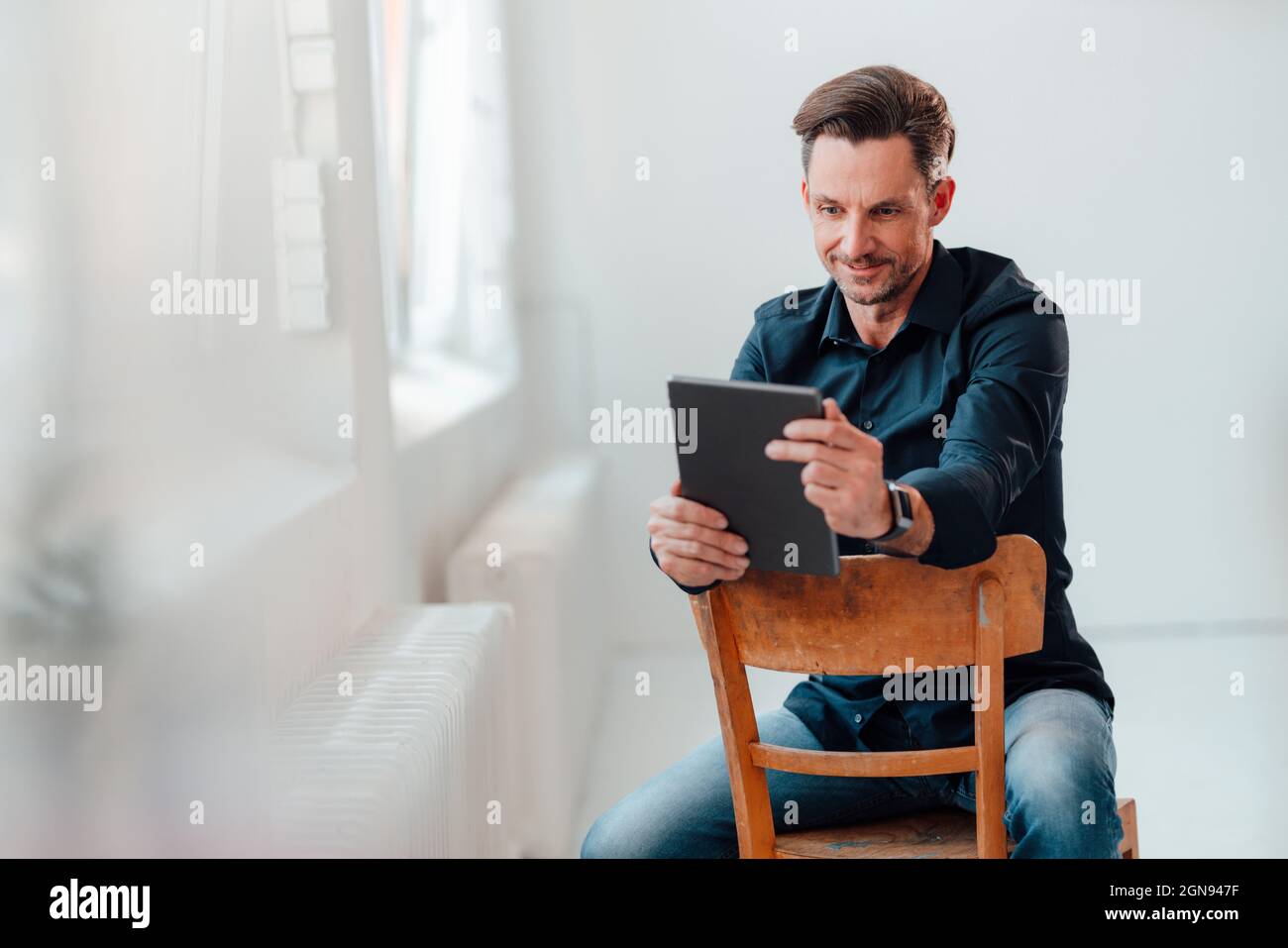 Man sitting chair backrest hi-res stock photography and images - Alamy