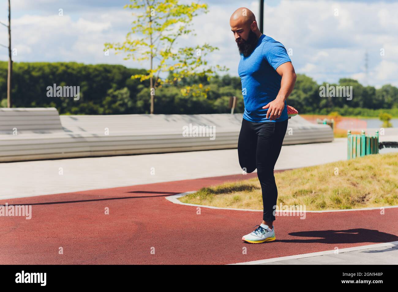 Young athlete running fast outdoors. Wearing sport cloth, doing wide ...