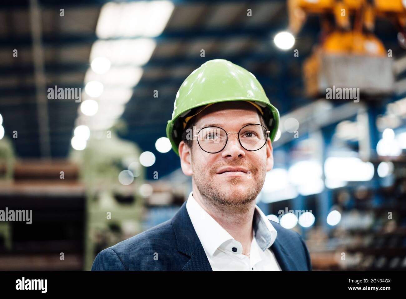 Male managing director discussing with coworker at metal industry Stock ...