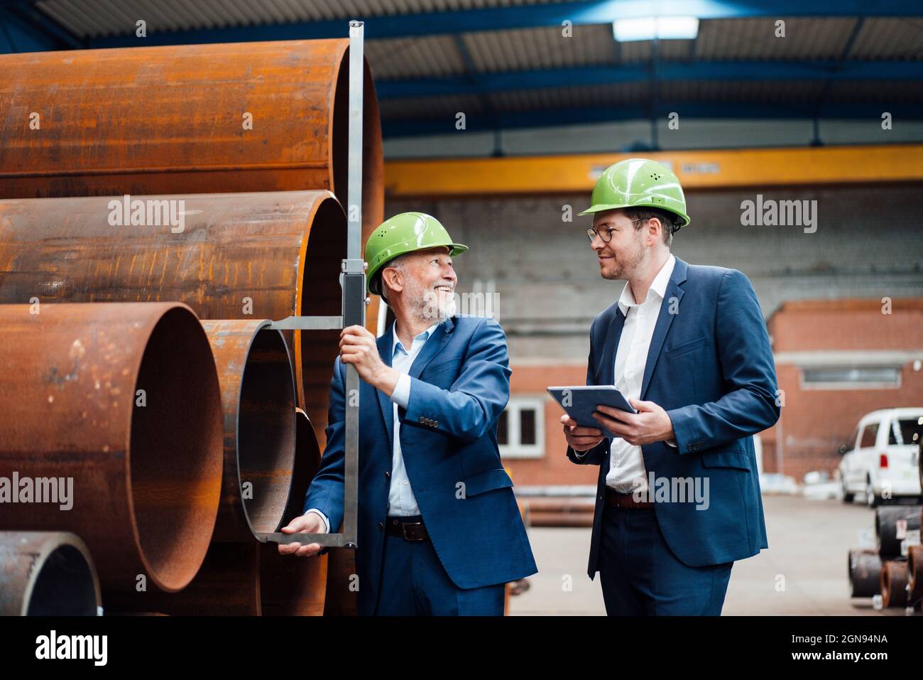 Male professional measuring pipe with caliper while standing by ...