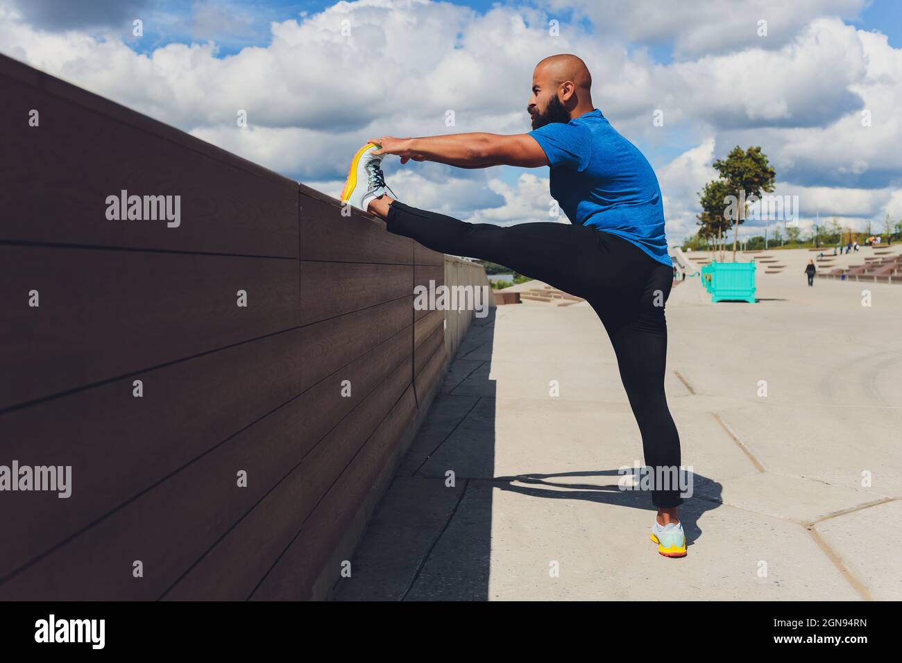 Young athlete running fast outdoors. Wearing sport cloth, doing wide ...