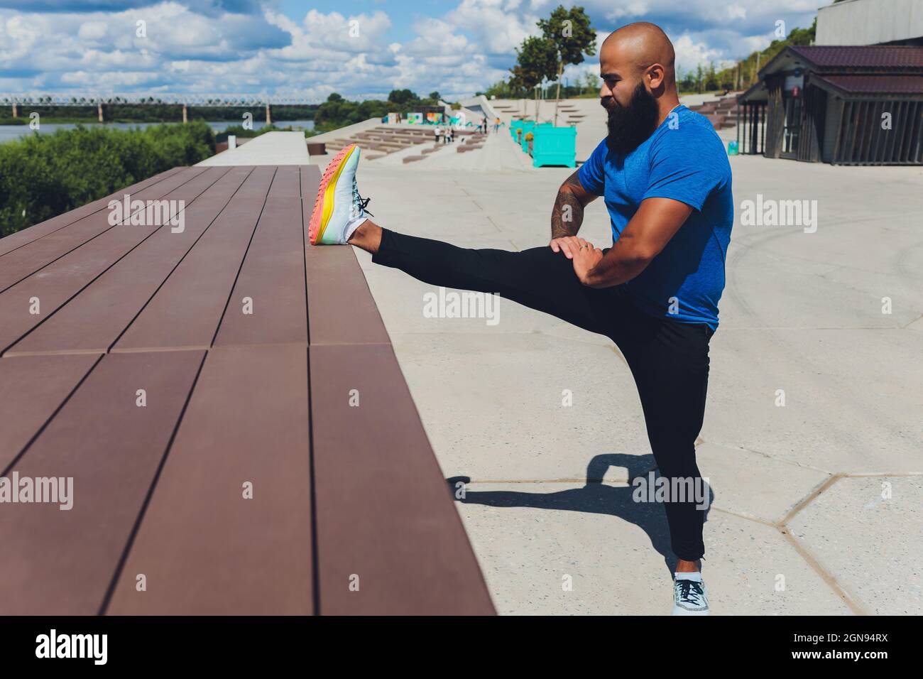 Young athlete running fast outdoors. Wearing sport cloth, doing wide ...