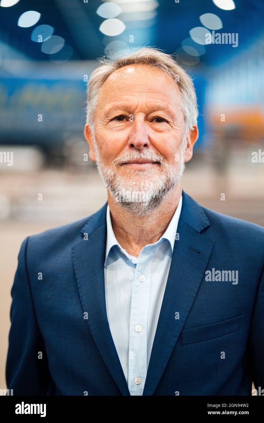 Smiling male managing director with gray hair in industry Stock Photo ...