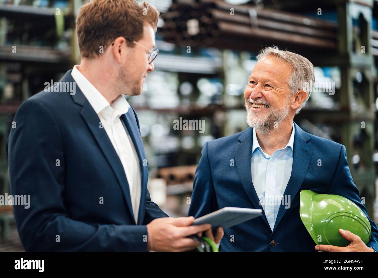 Male managers having discussion over digital tablet in factory Stock ...