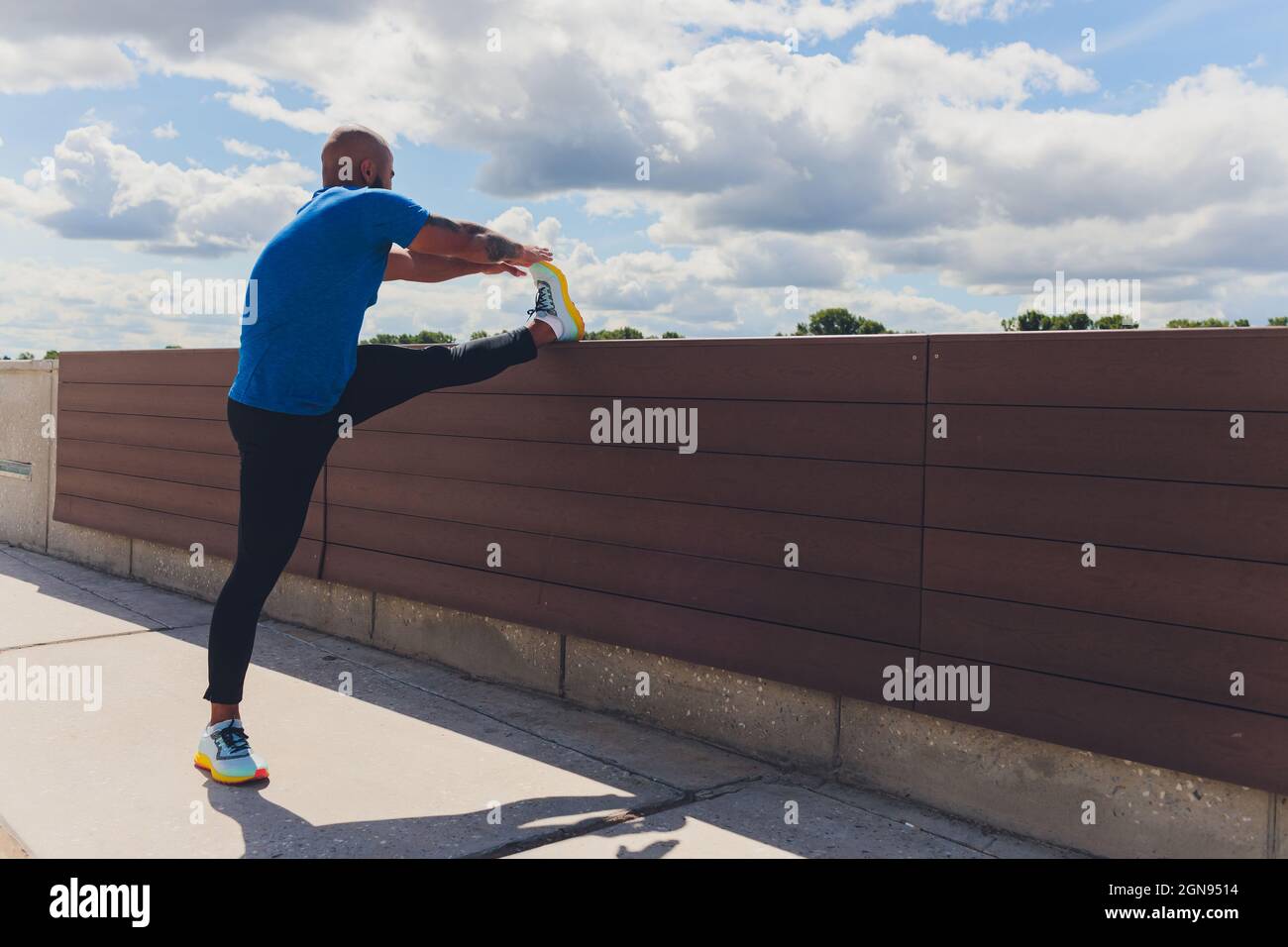 Young athlete running fast outdoors. Wearing sport cloth, doing wide ...