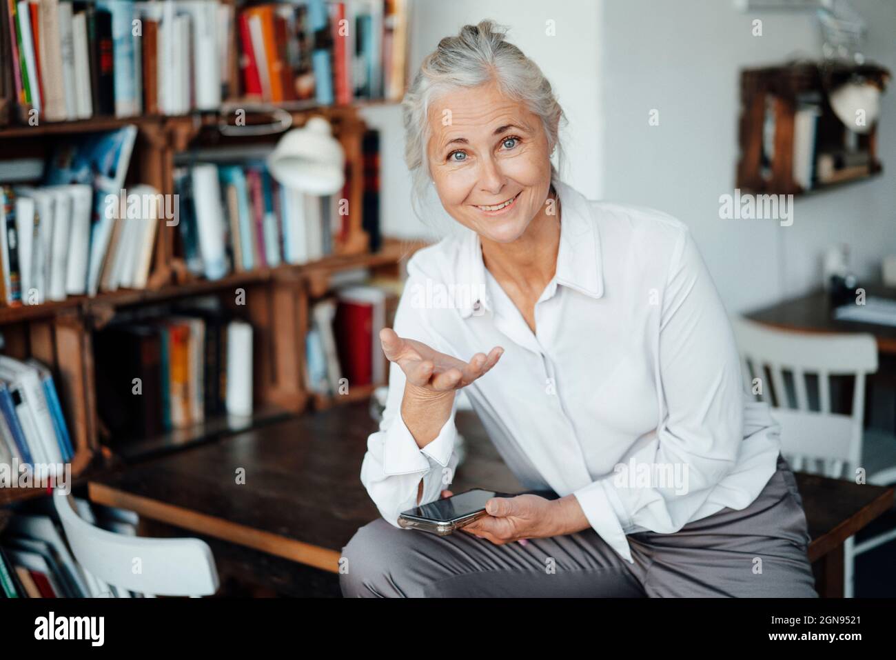 Cheerful female owner smiling hi-res stock photography and images - Alamy